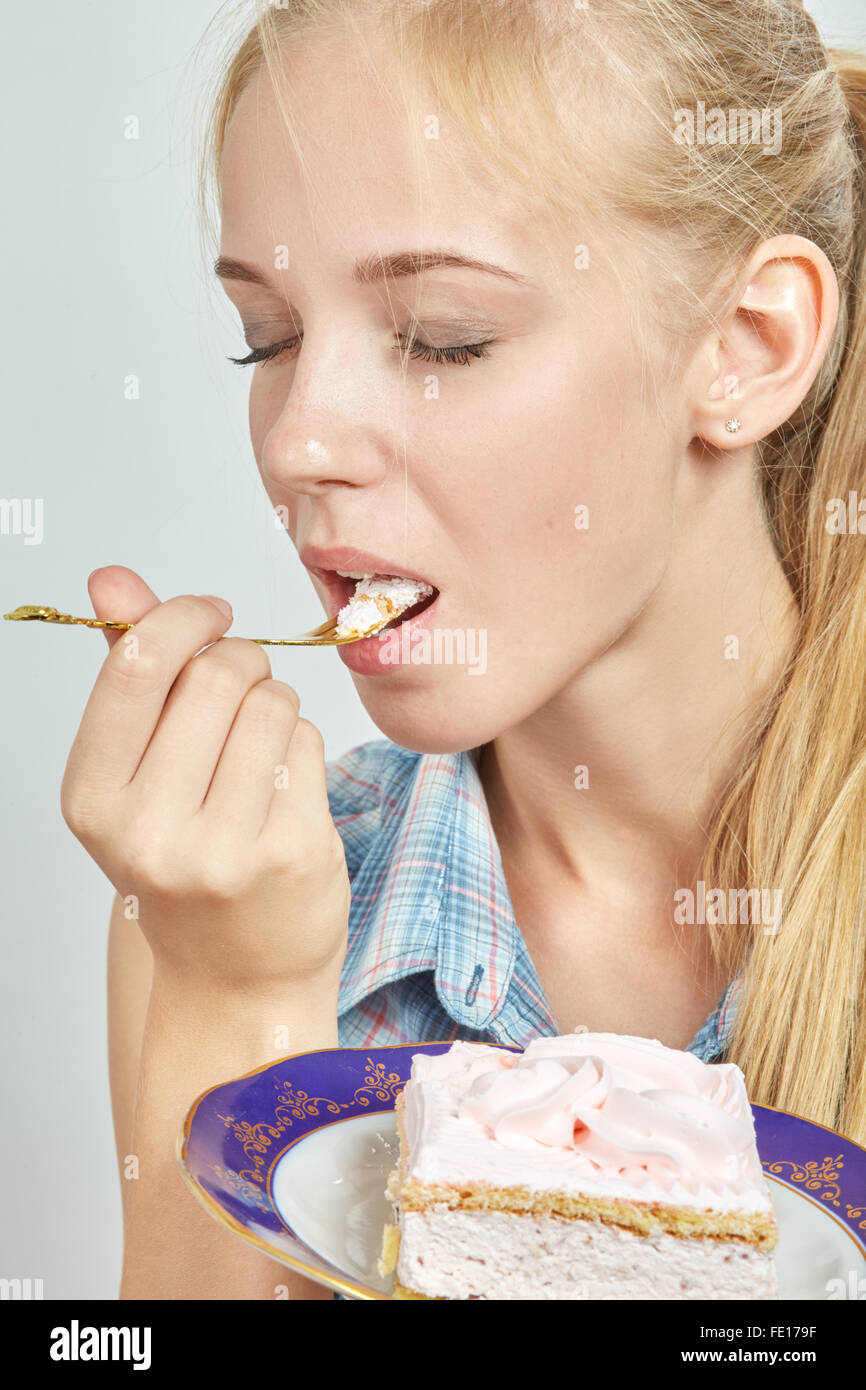pretty girl eats sweet cake Stock Photo - Alamy