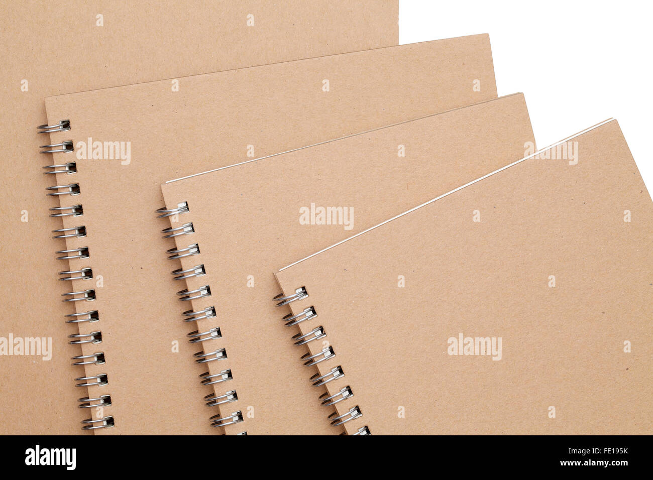 stack of spiral brown notebook on white background Stock Photo - Alamy