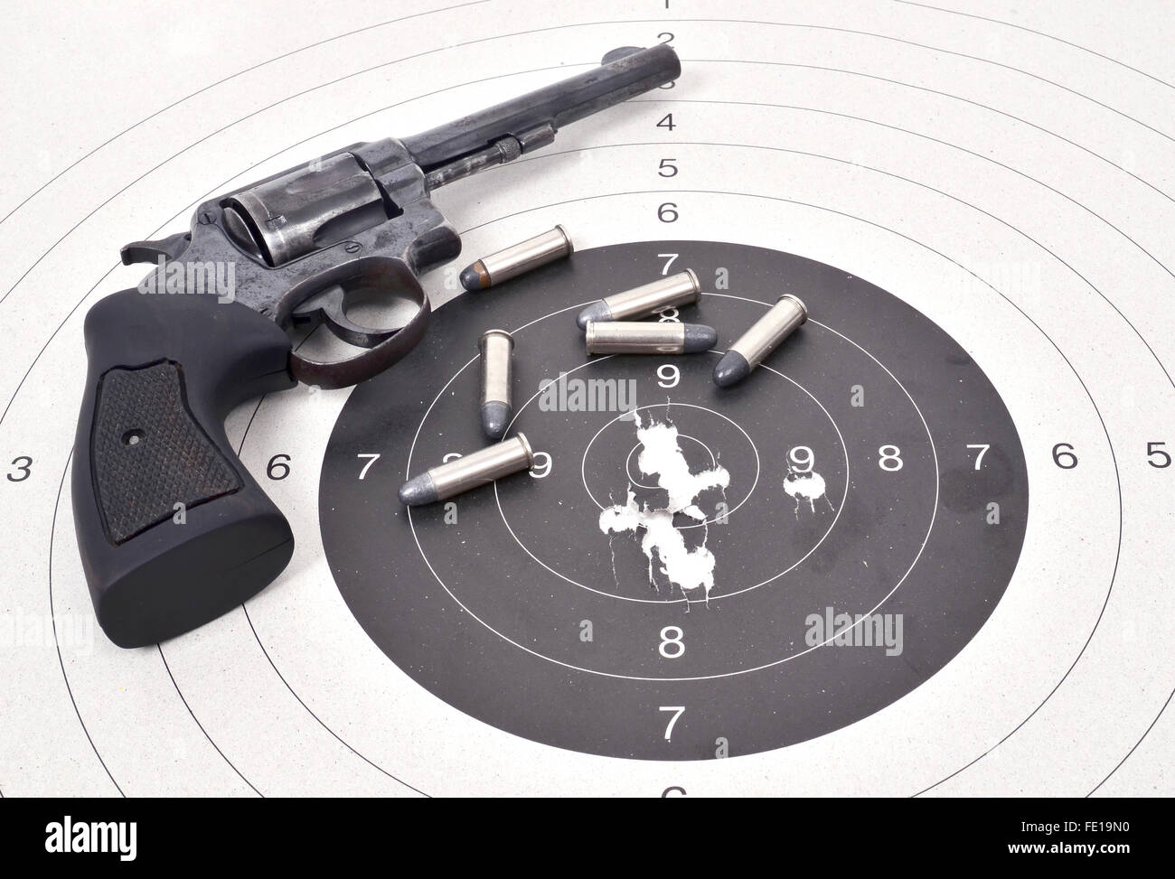 old revolver gun with bullet on the target Stock Photo - Alamy