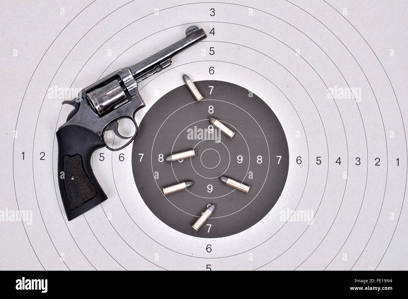 old revolver gun with bullet on the target Stock Photo - Alamy