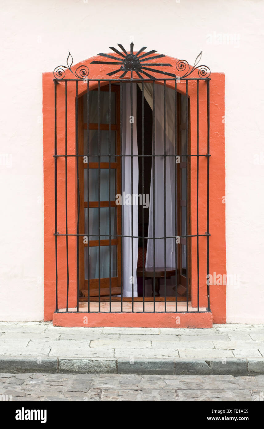 Wrought iron grate with sunburst design over open windows, Oaxaca City ...