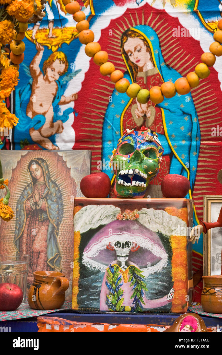 Religious icons, skull, flowers and fruit decorate an altar for Day of ...