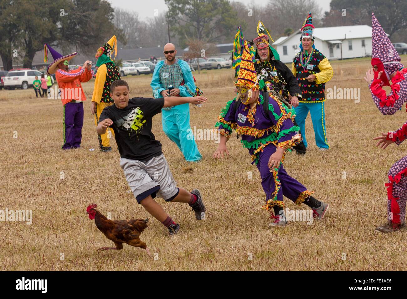 Revelers try to grab a live chicken during the traditional Cajun Courir ...