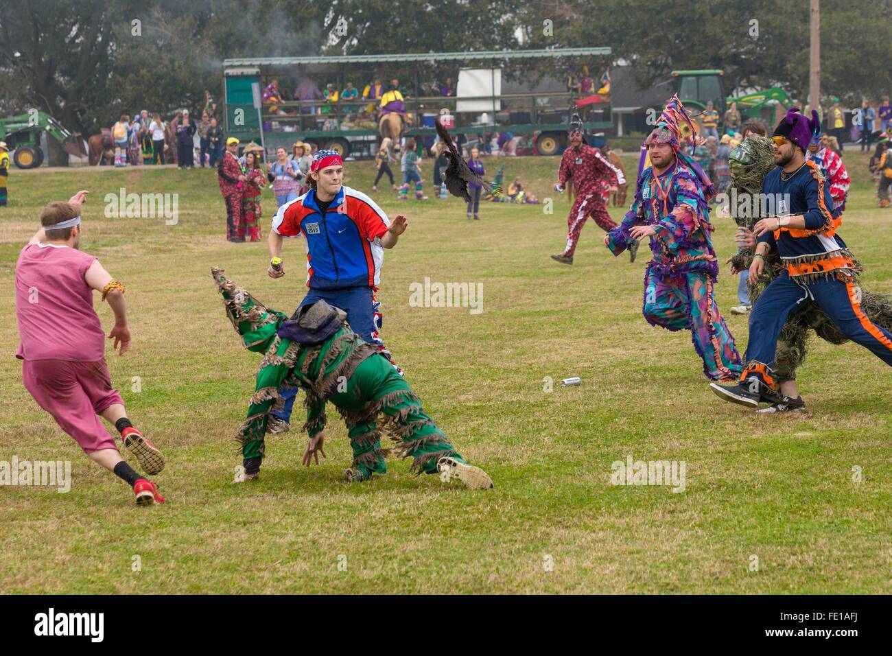 Revelers try to grab a live chicken during the traditional Cajun Courir ...