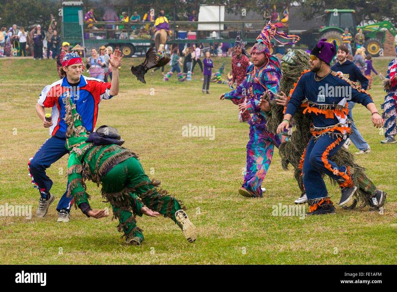 Revelers try to grab a live chicken during the traditional Cajun Courir ...
