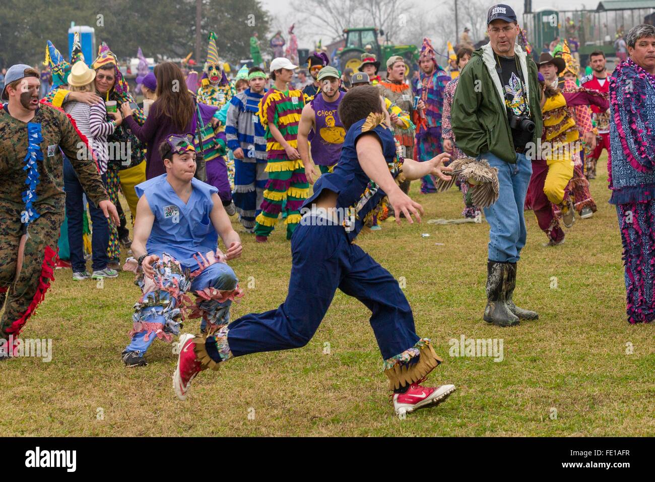 Revelers try to grab a live chicken during the traditional Cajun Courir ...