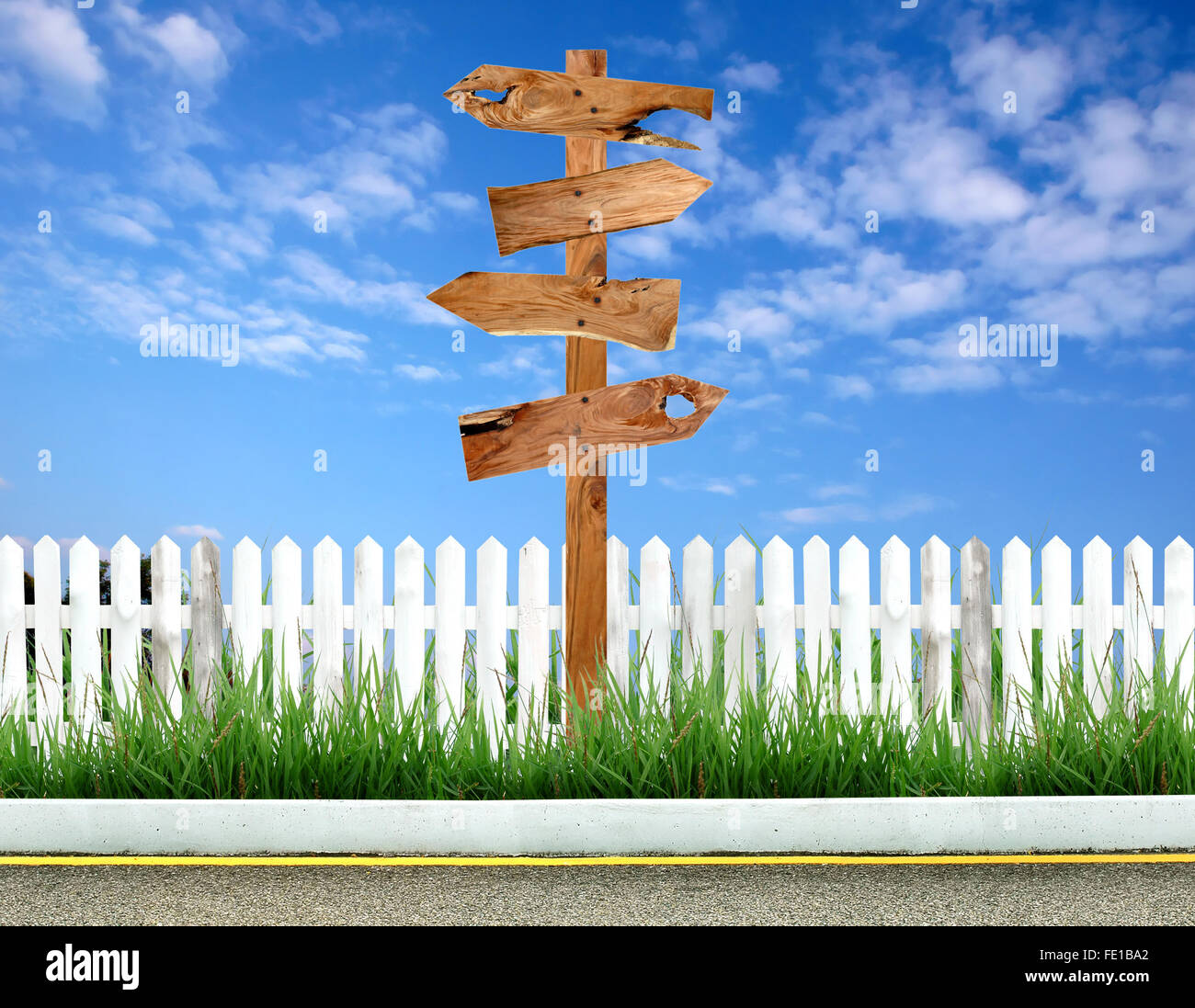 wooden signpost with white fence and blue sky Stock Photo - Alamy