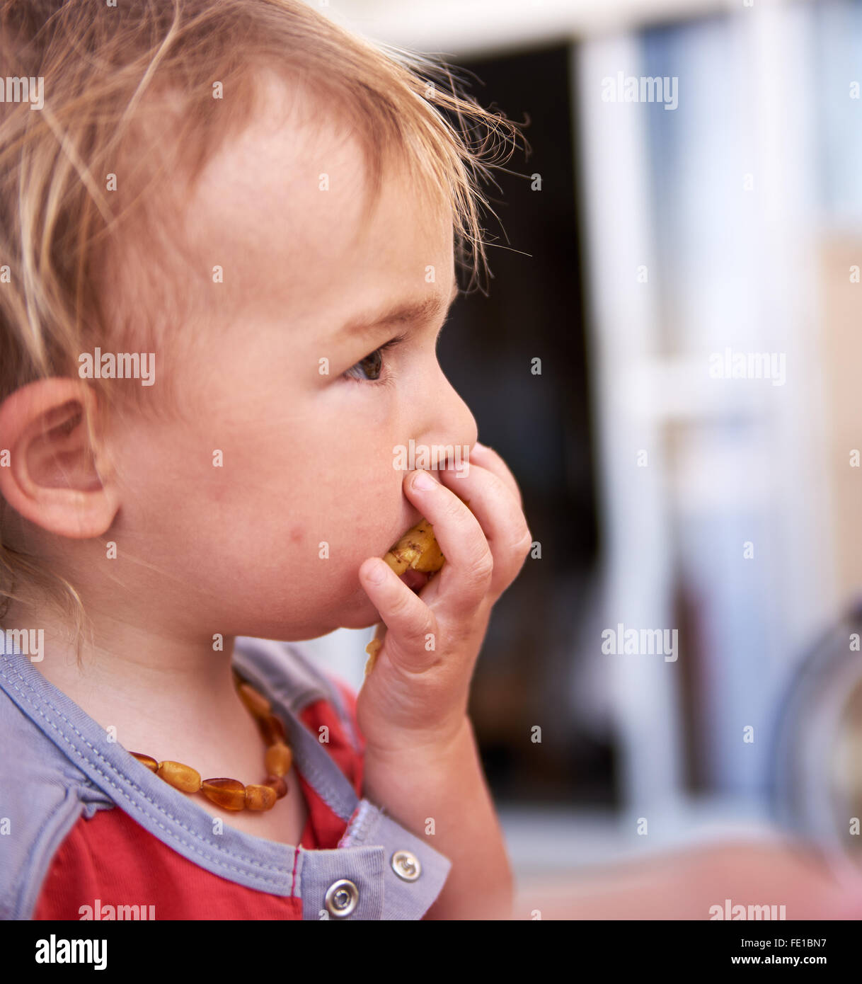 Cute fun child little baby boy eats at the table Stock Photo - Alamy