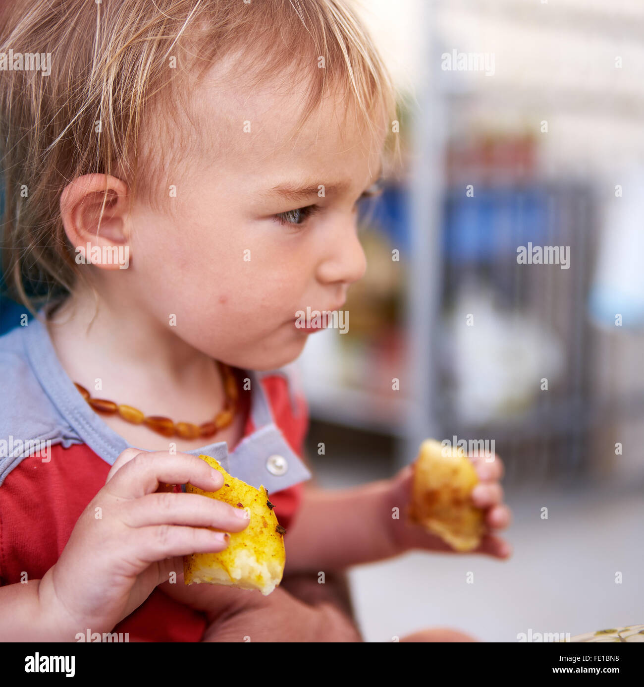 Cute fun child little baby boy eats at the table Stock Photo - Alamy