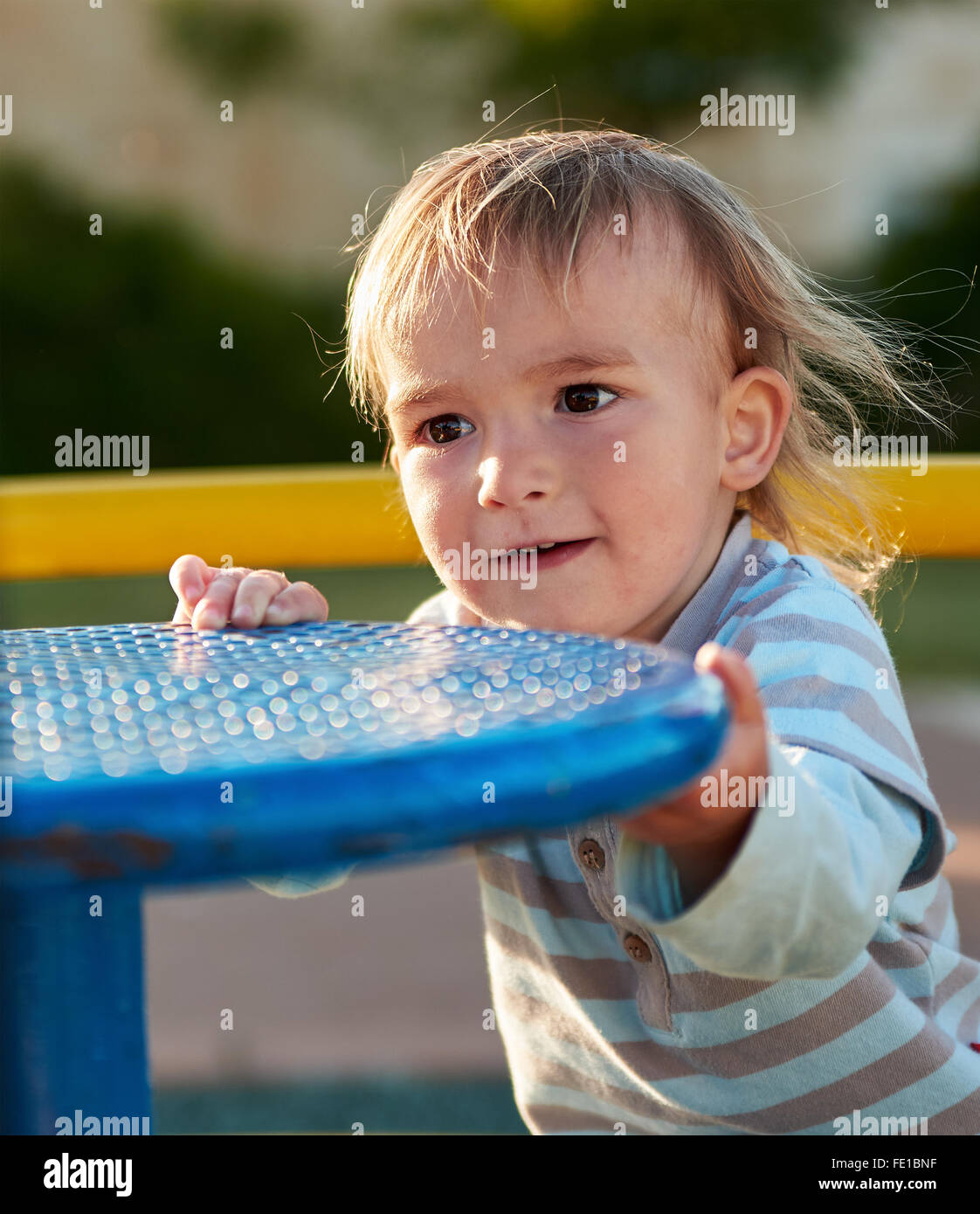 Cute baby boy child playing in play area. Toddler at the playground ...