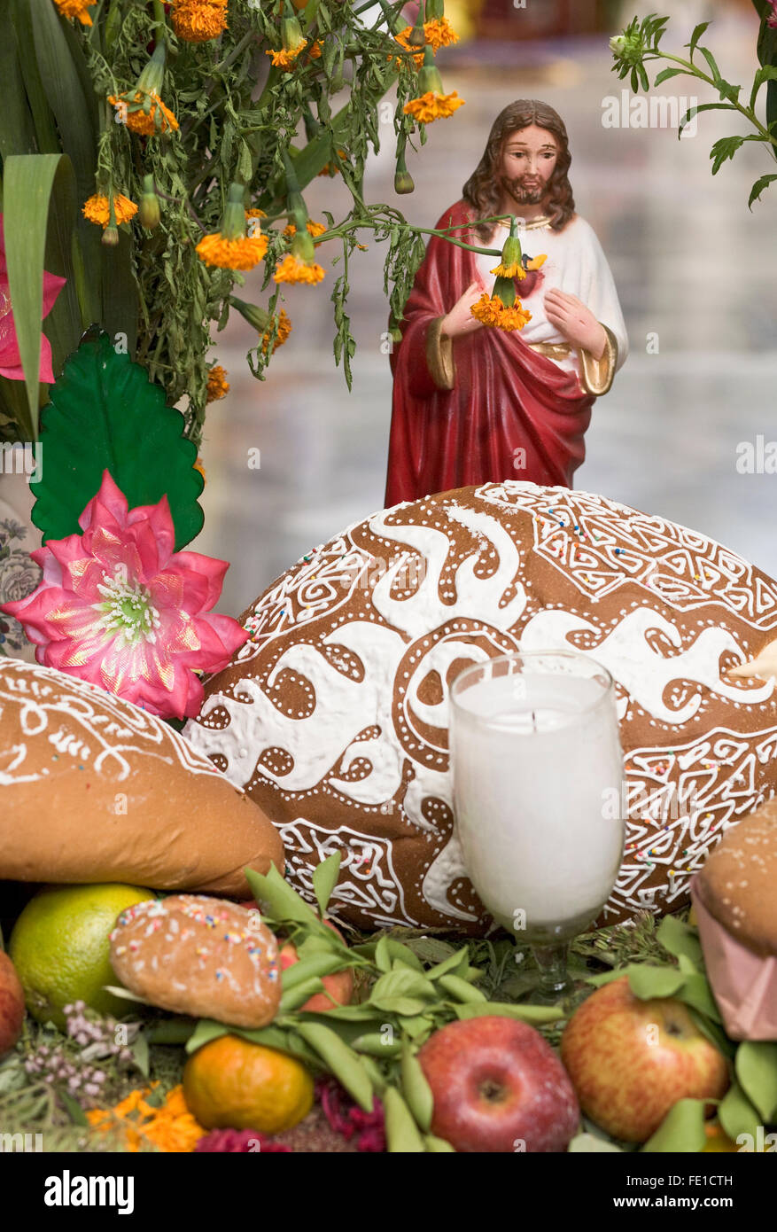 Traditional Pan de Muertos bread, fruit and flower offerings on altar ...