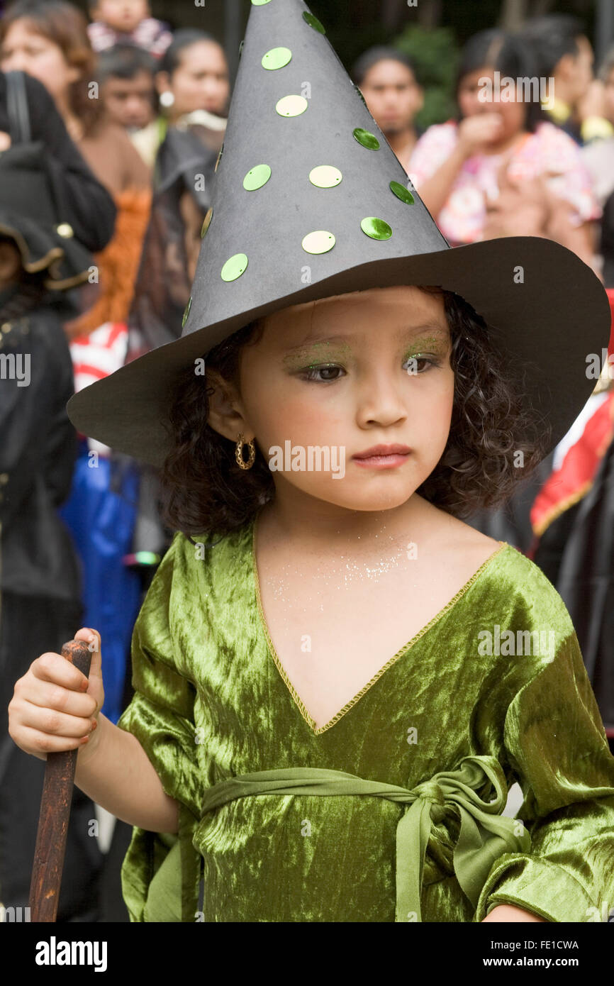 A beautiful little girl dressed in a witch costume for Halloween parade ...