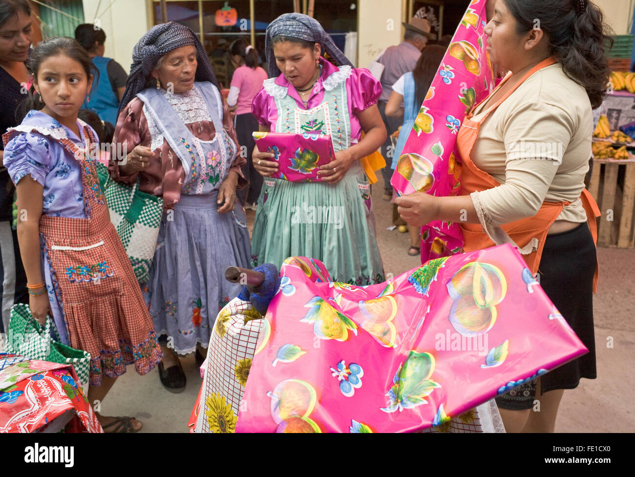 Local indigenous women in colorful traditional dress shopping for ...