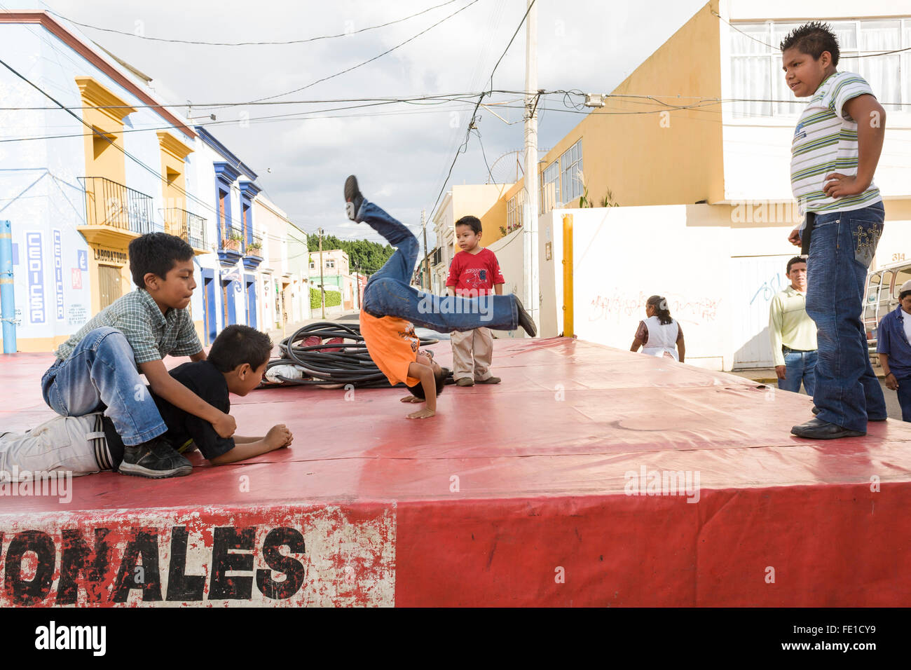 Local Mexican children playing on a festival stage in city neighborhood ...