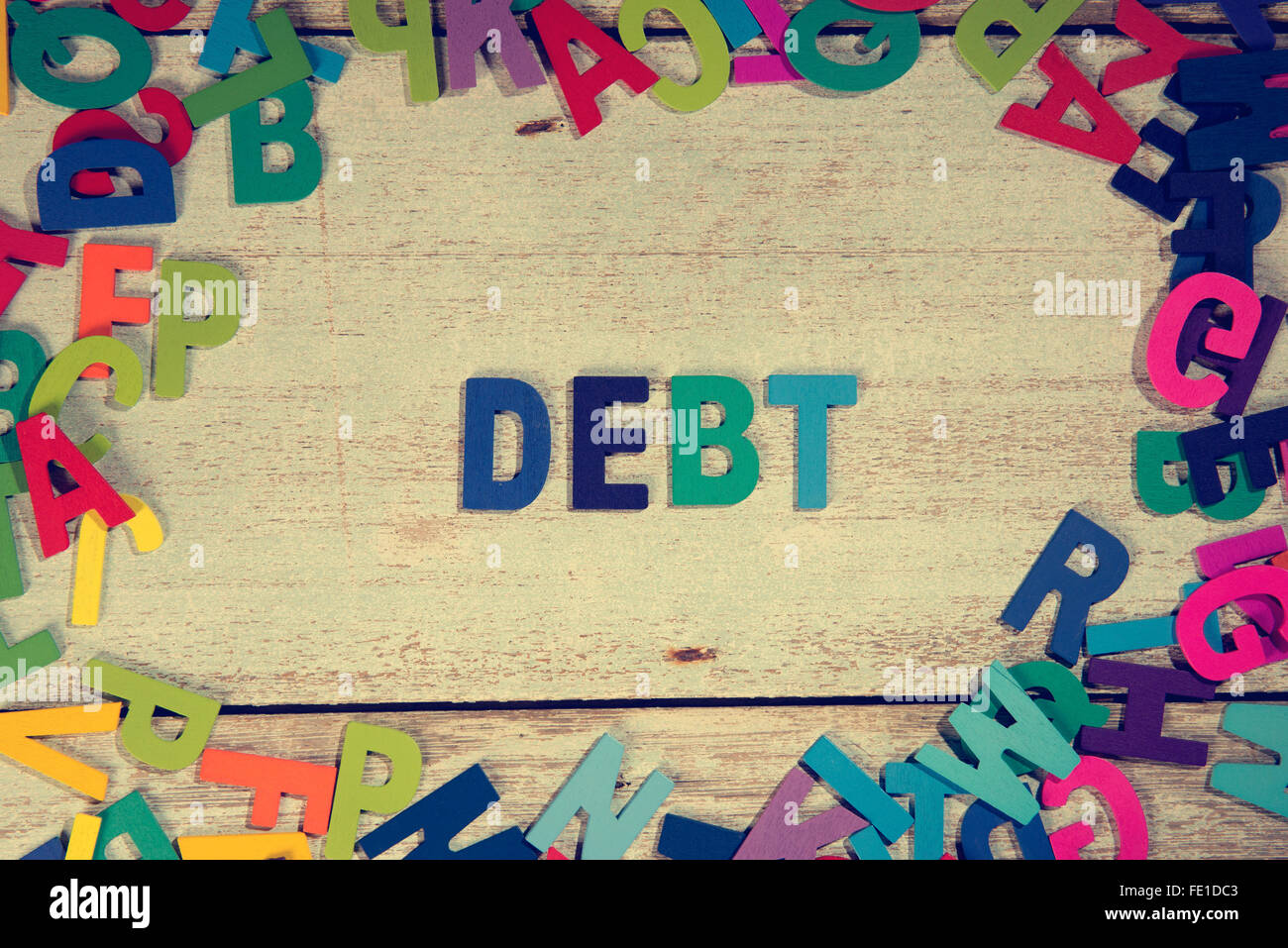 debt word block concept photo on plank wood Stock Photo - Alamy