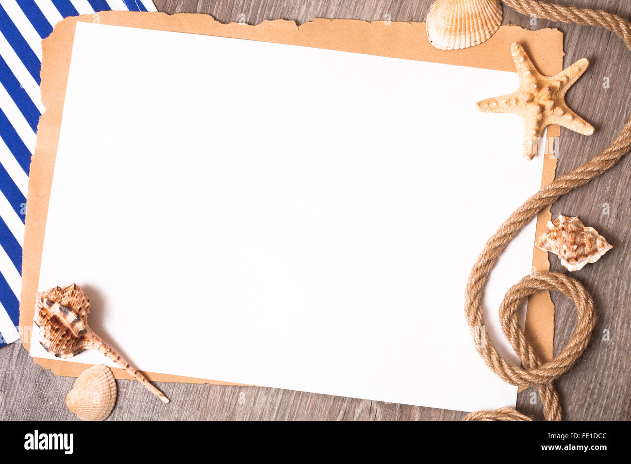 Background with a white sheet of paper, rope and shells in a marine ...