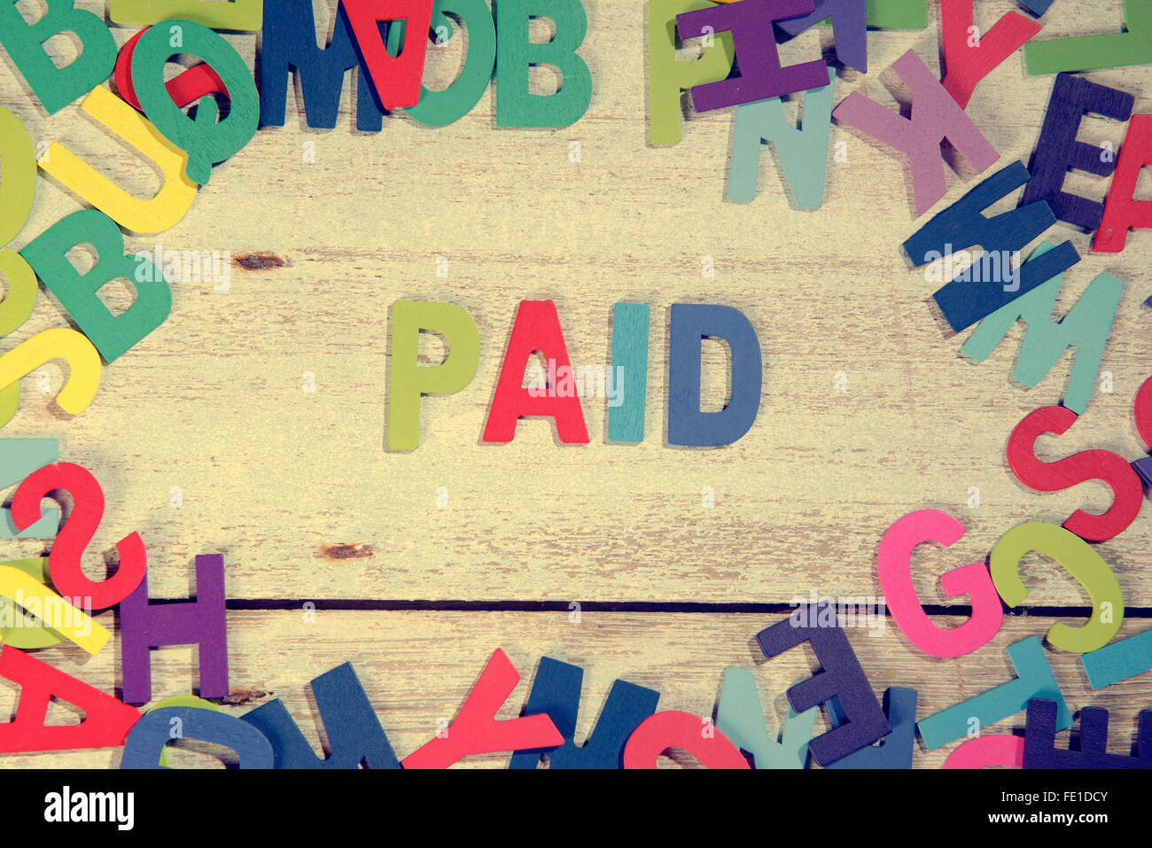 Wooden blocks word paid hi-res stock photography and images - Alamy