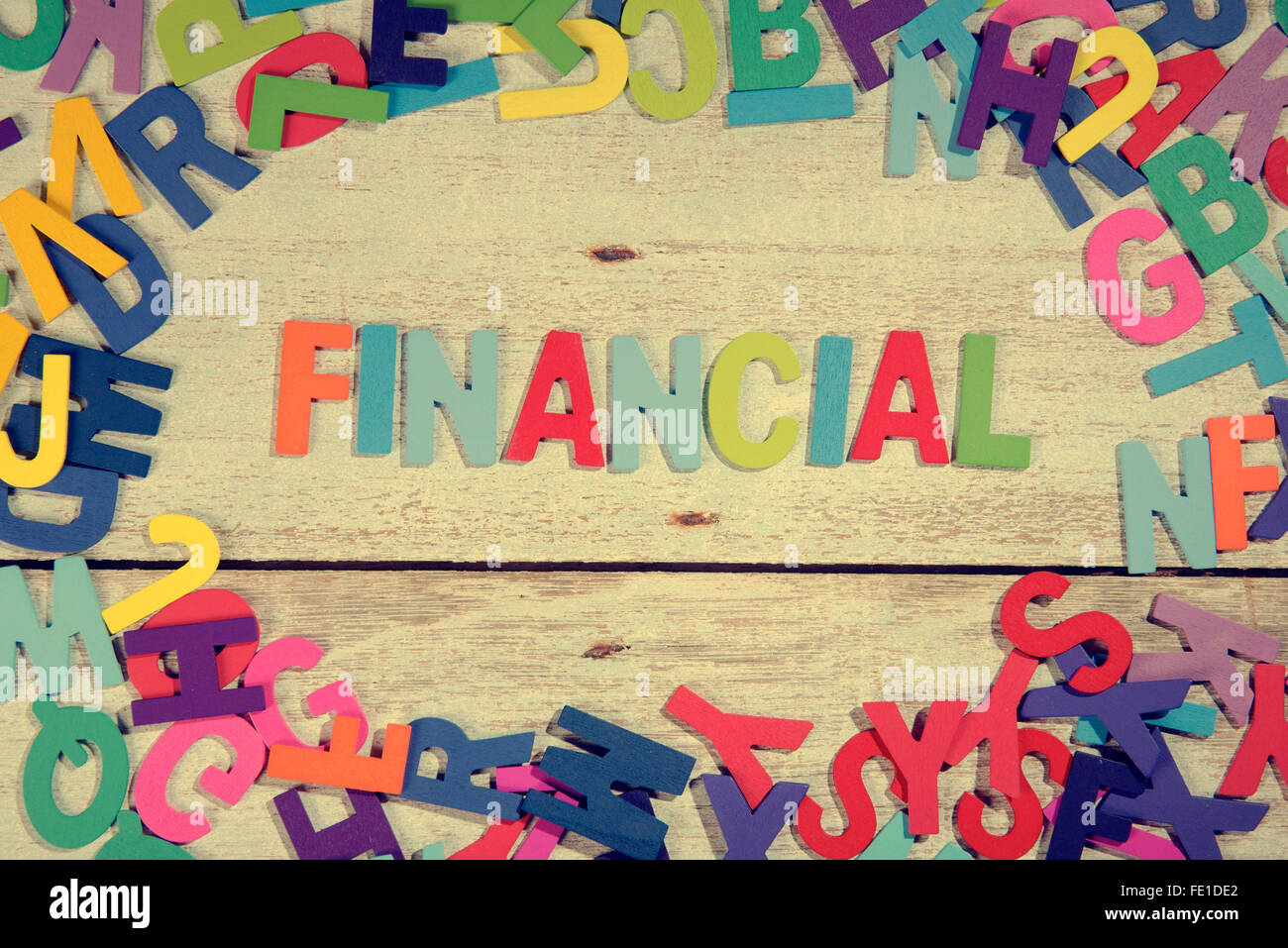 financial word block concept photo on plank wood Stock Photo - Alamy