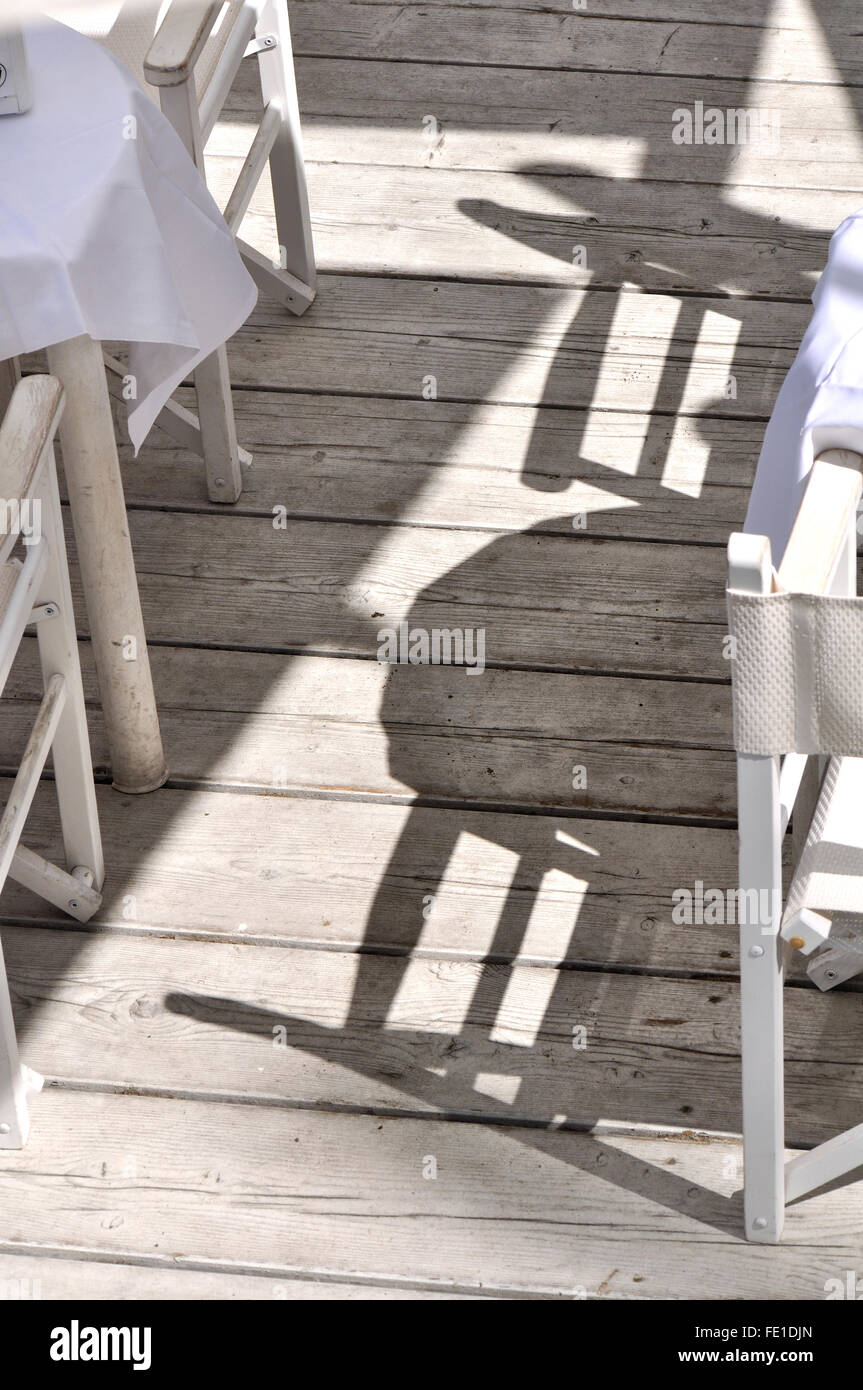 chairs and tables shadows on wooden floor Stock Photo - Alamy