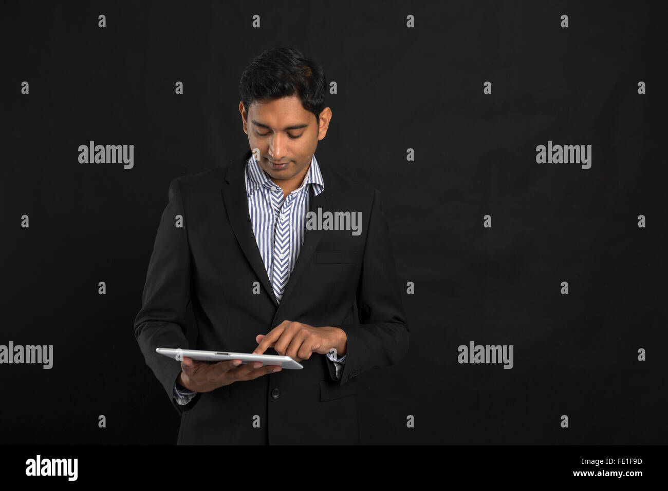 indian business man with a tablet and dark background Stock Photo - Alamy