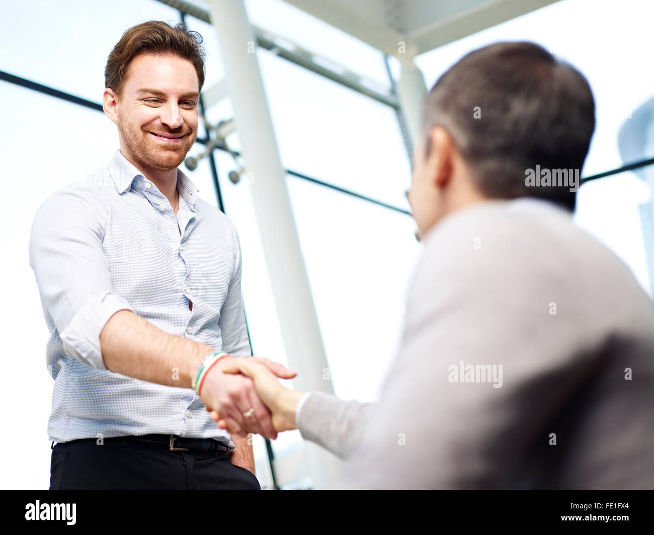 businesspersons greeting each other in office Stock Photo - Alamy