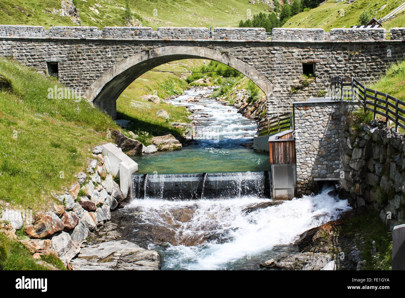Bridge over mountain river. Alpine view Stock Photo - Alamy