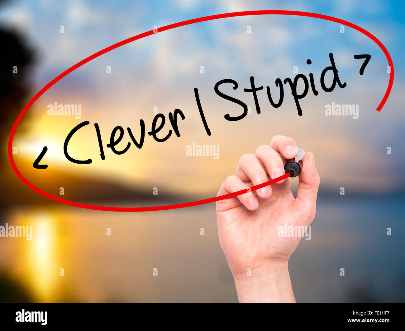 Man Hand writing Clever - Stupid with black marker on visual screen ...