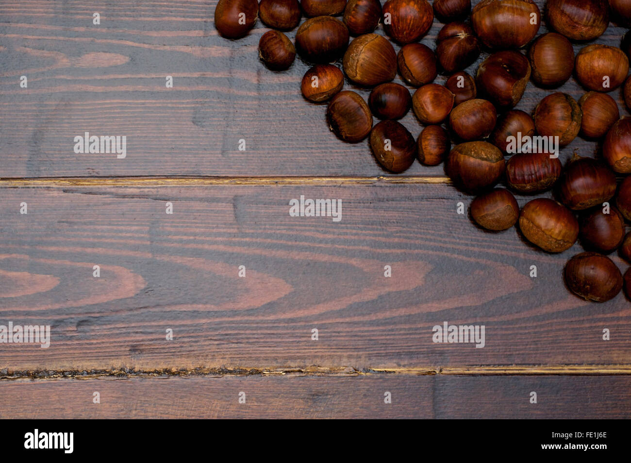 Chestnut in the corner of the wooden background Stock Photo - Alamy