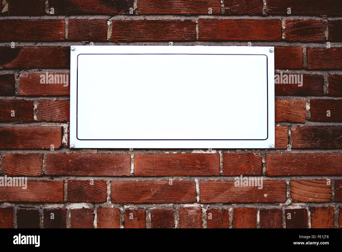 Blank street name board on brick wall as copy space Stock Photo - Alamy