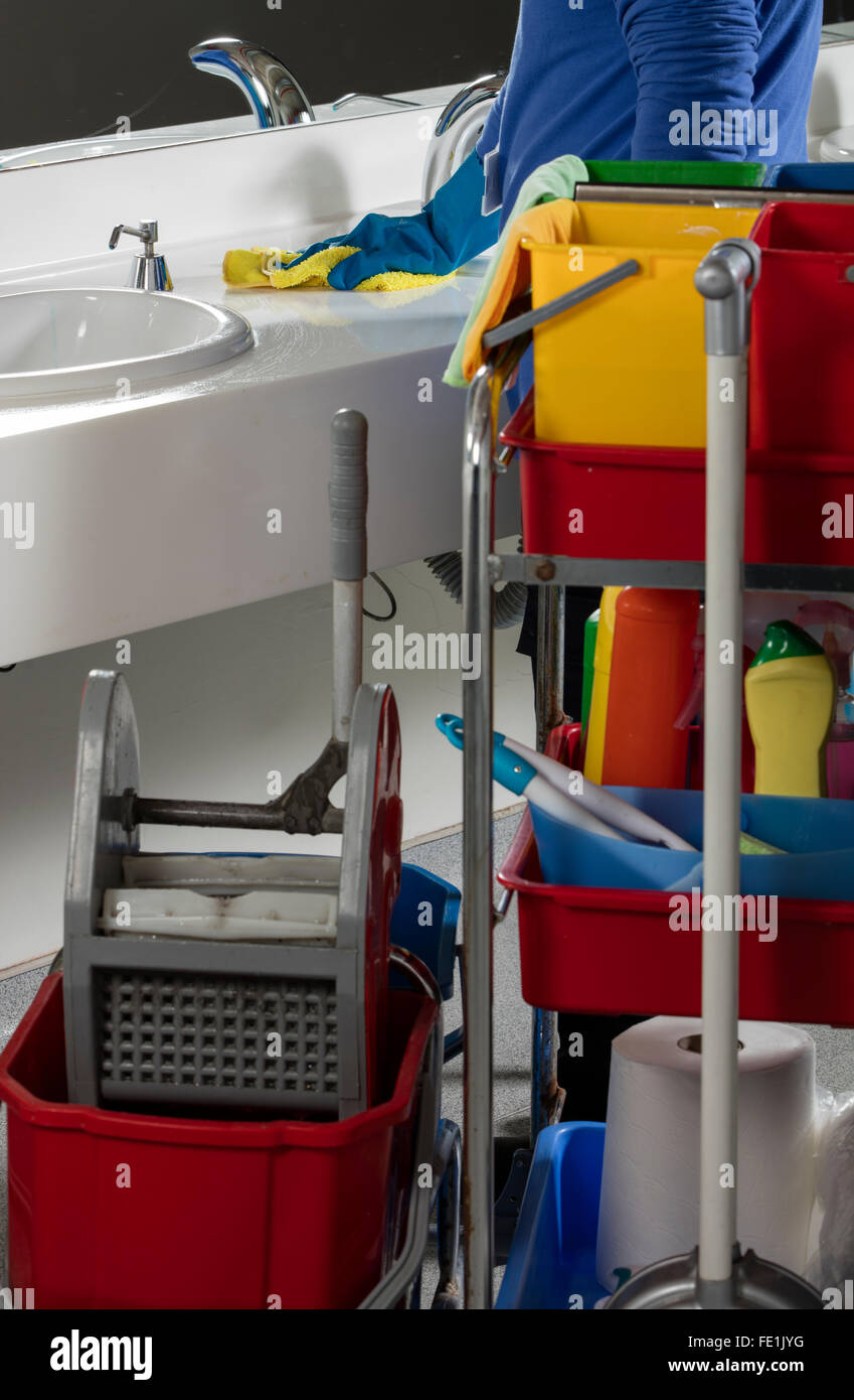 rubber gloved hand cleaning sink with duster Stock Photo - Alamy