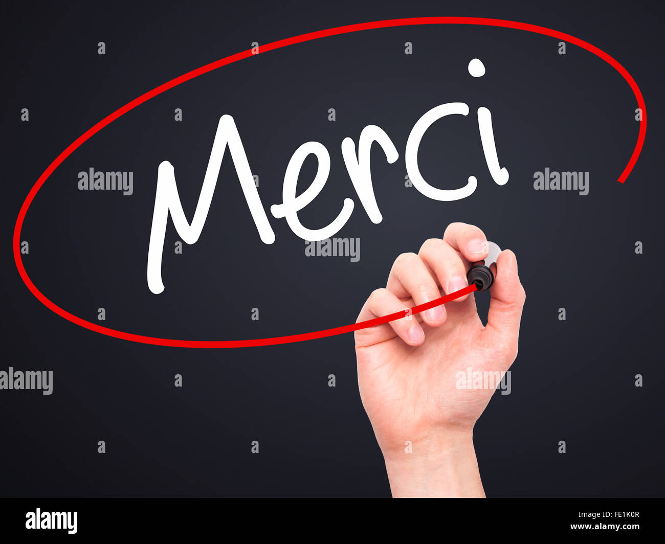 Man Hand writing Merci (Thank You In French) with black marker on ...