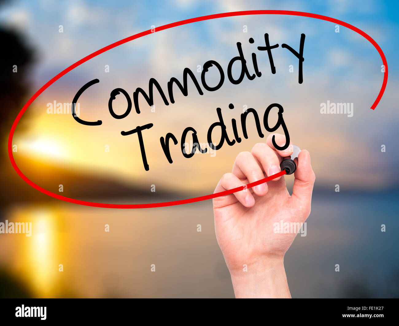 Man Hand writing Commodity Trading with black marker on visual screen. Isolated on background ...