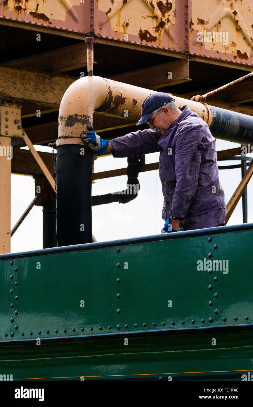 Steam train taking on water at Watchet Station on the West Somerset ...
