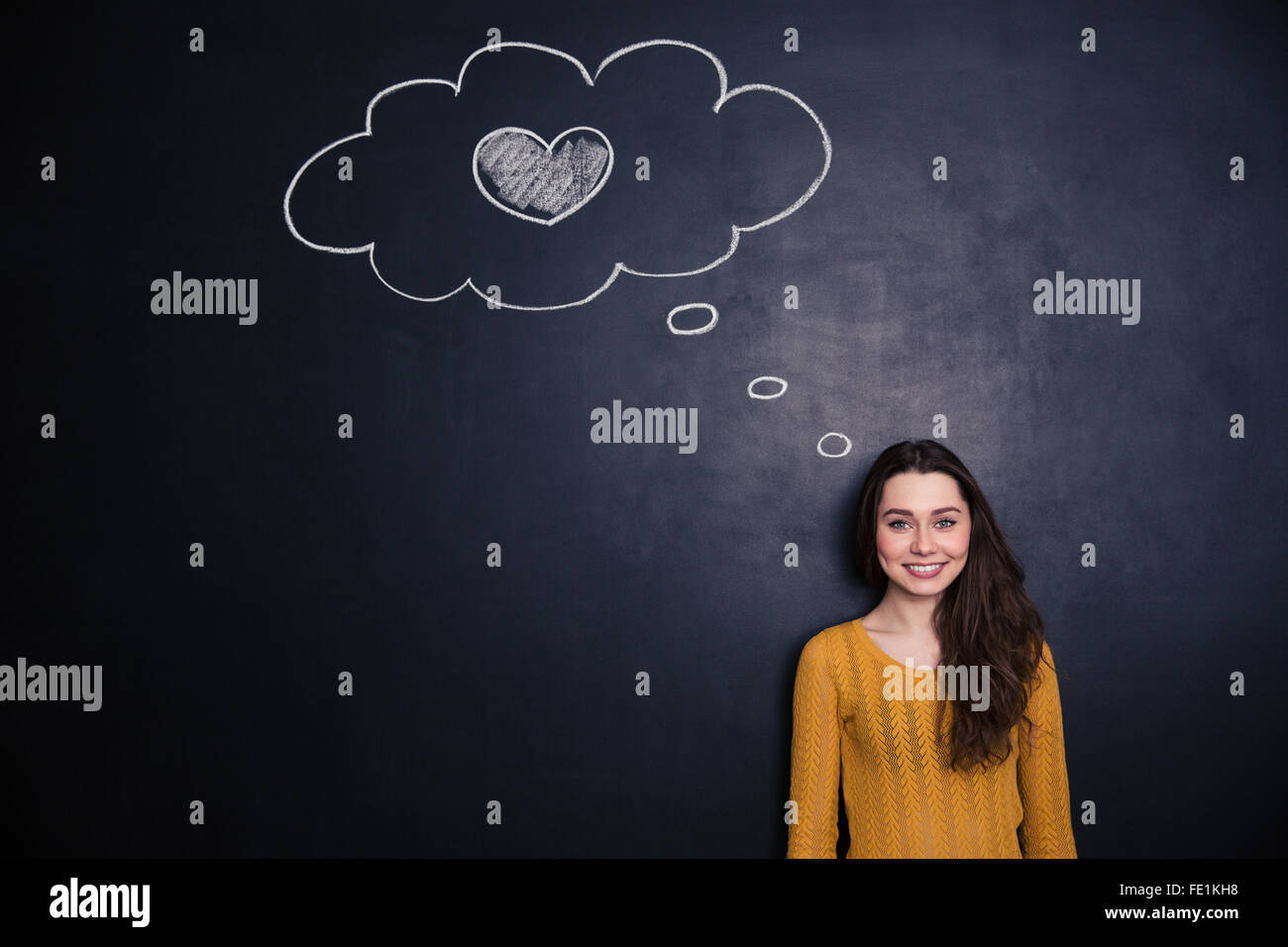 Beautiful happy young woman thinking about love and standing with ...