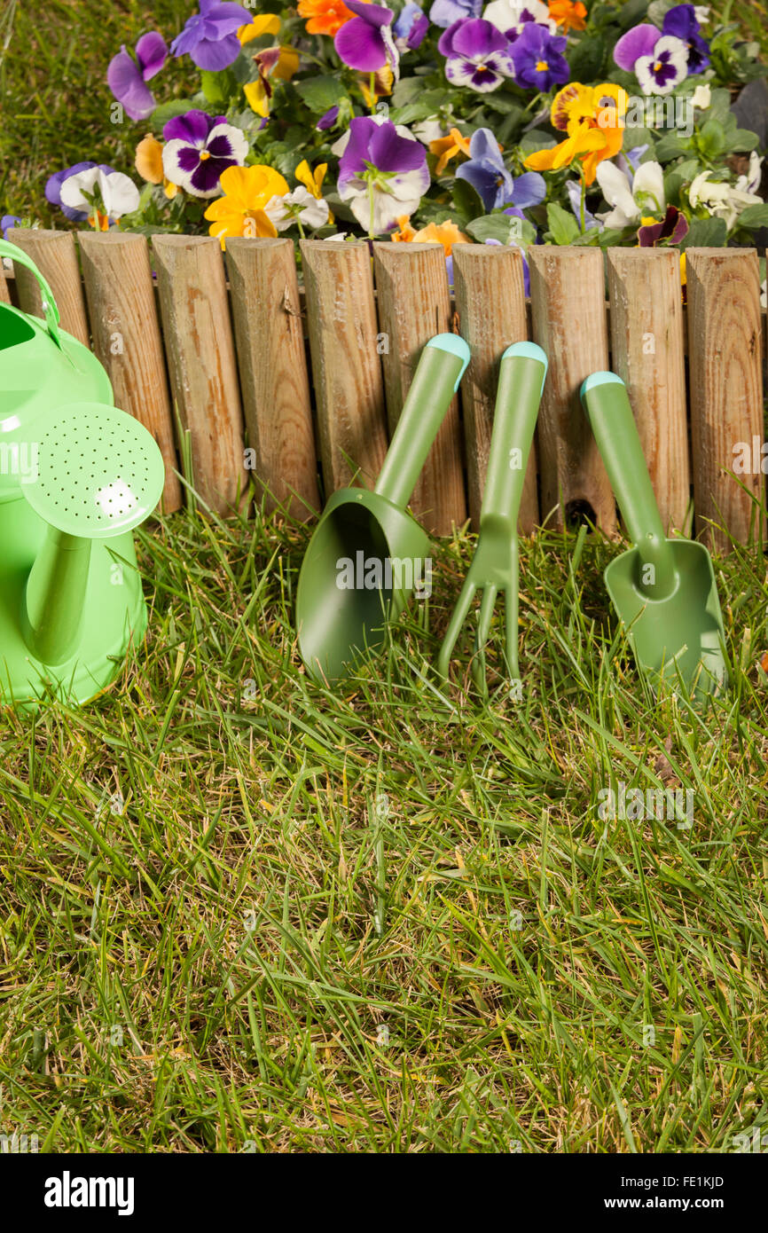 Garden tools on grass in yard Stock Photo - Alamy