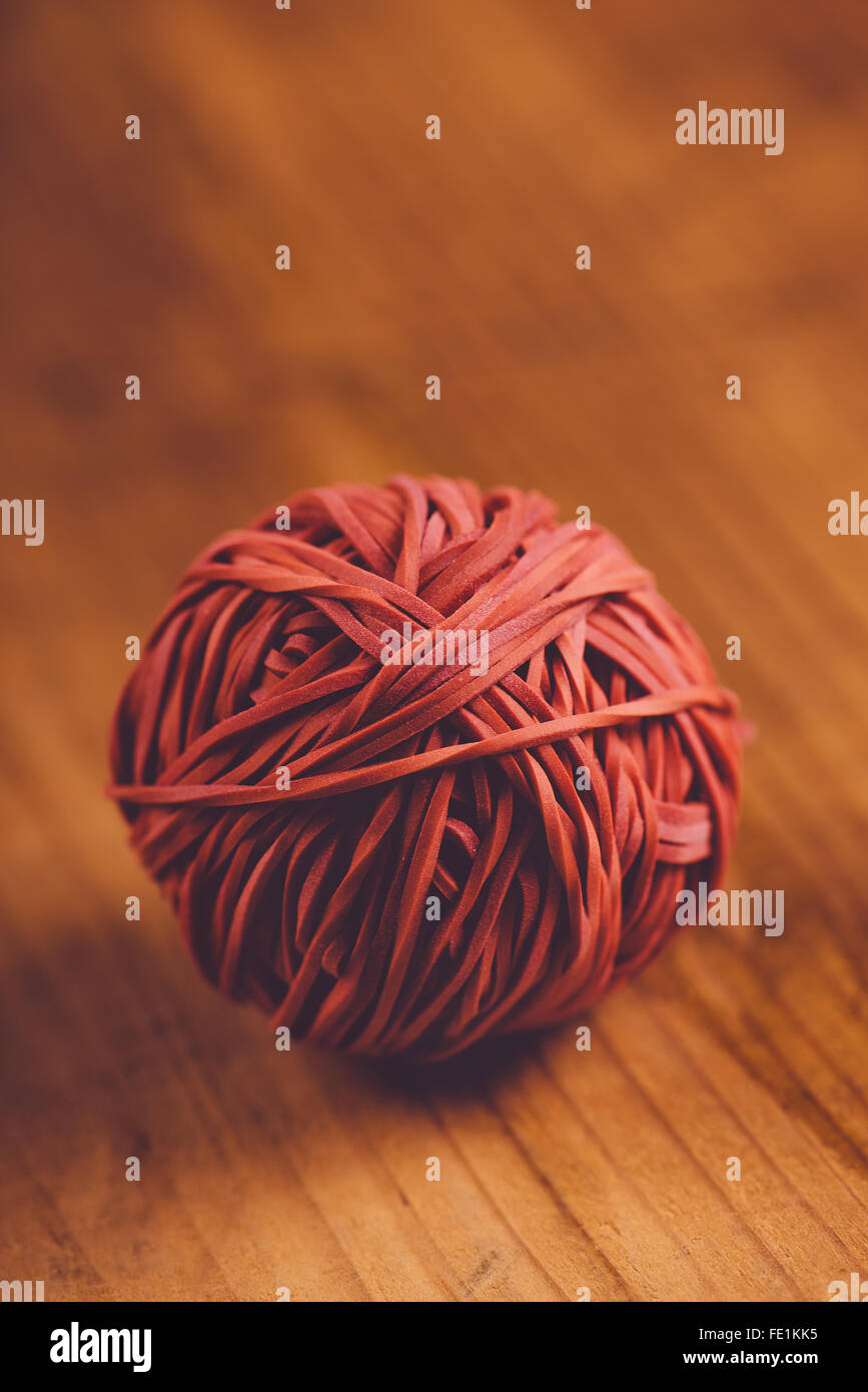 Rubber jar rings ball on rustic wooden desk, stress relief exercise ...