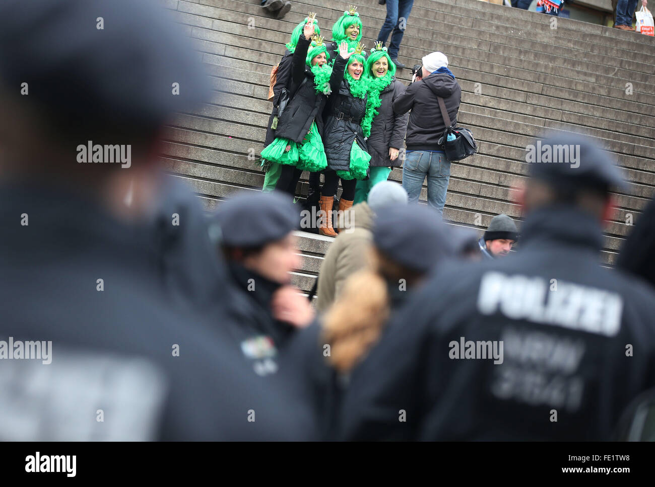 A group of cheering Carnival enthusiasts pose on the steps leading up ...