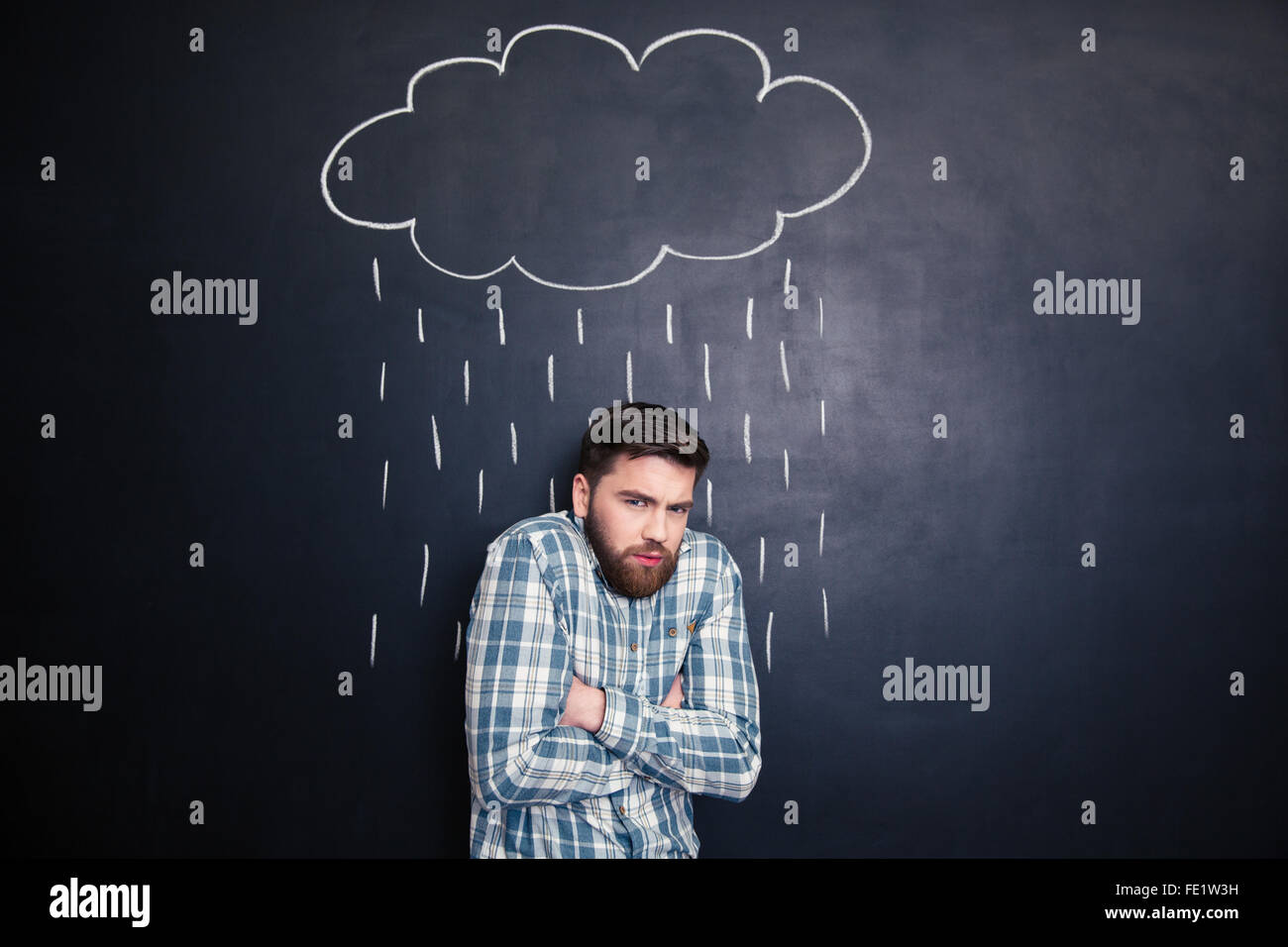 Handsome bearded man feeling cold standing under the rain drawn on ...
