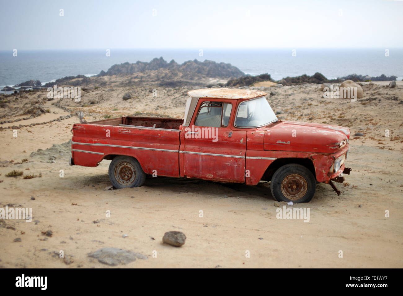 Deserted classic car near the Playa la Virgen, Atacama, region, Chile ...