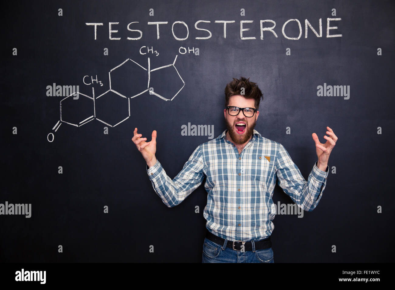 Crazy angry young professor of chemistry in glasses standing and ...