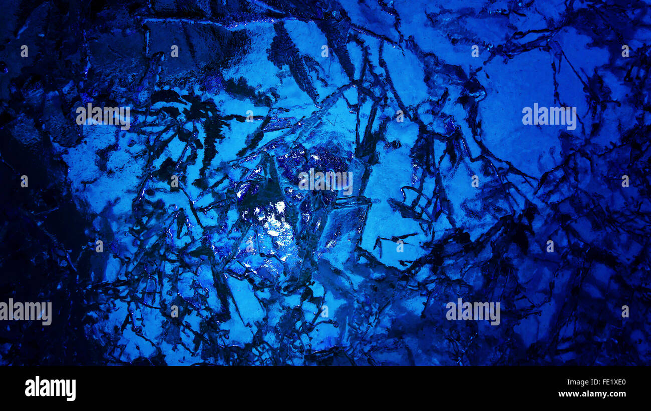 Chunks and blocks of cold frozen ice with light shining through the ...
