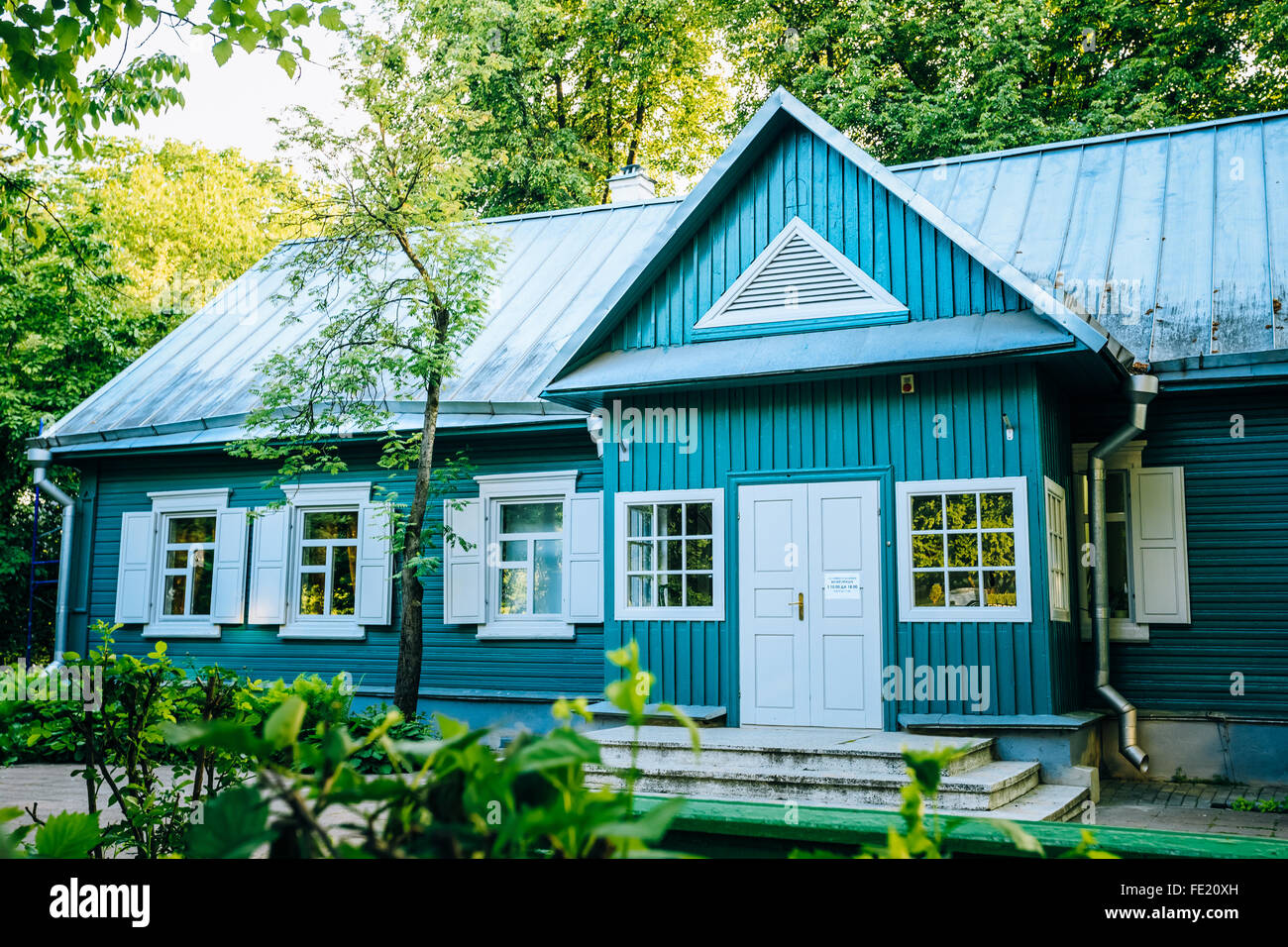 Ancient wood painted blue house with white shutters, door and porch in ...