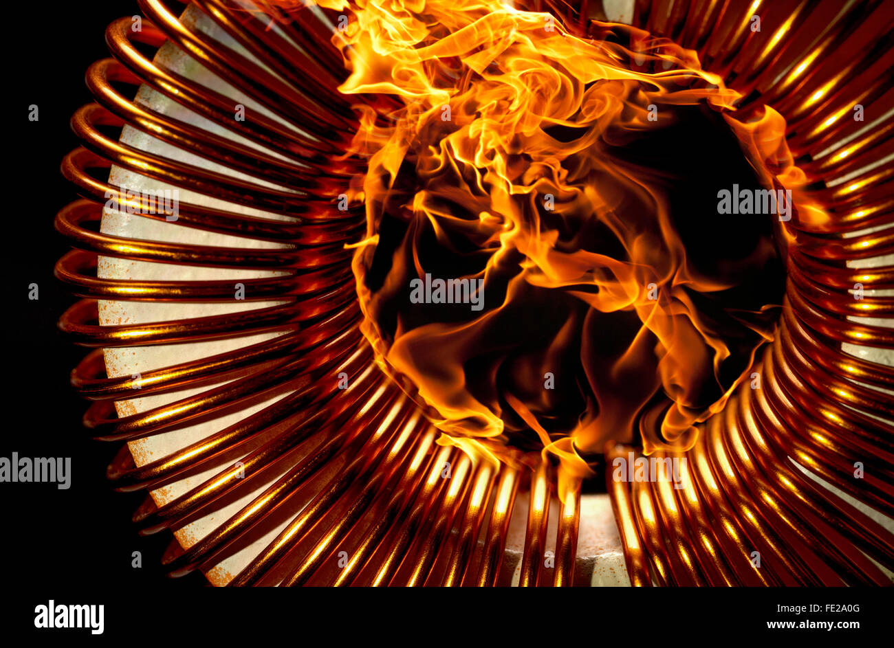 burning inductor coil in black back Stock Photo - Alamy