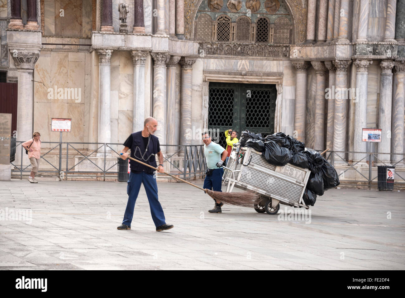 A daily early morning clean-up as a council street cleaner uses a broom ...