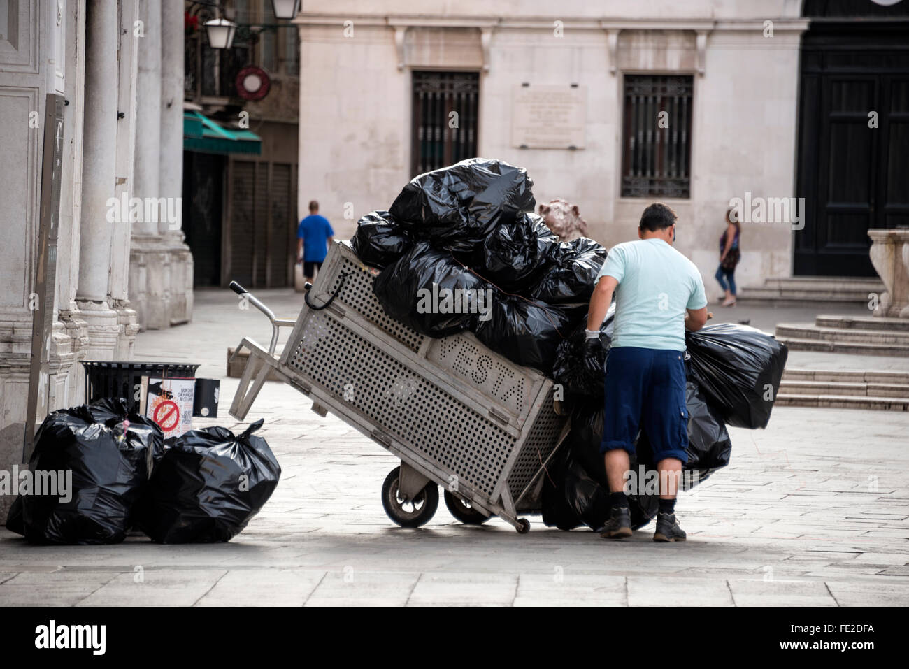 A daily early morning street clean as a council street cleaner loads ...