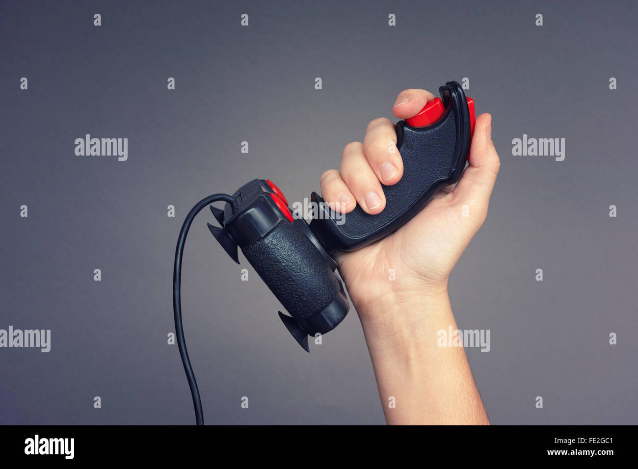 Person holds retro joystick in her hand. Gaming joystick from the mid ...
