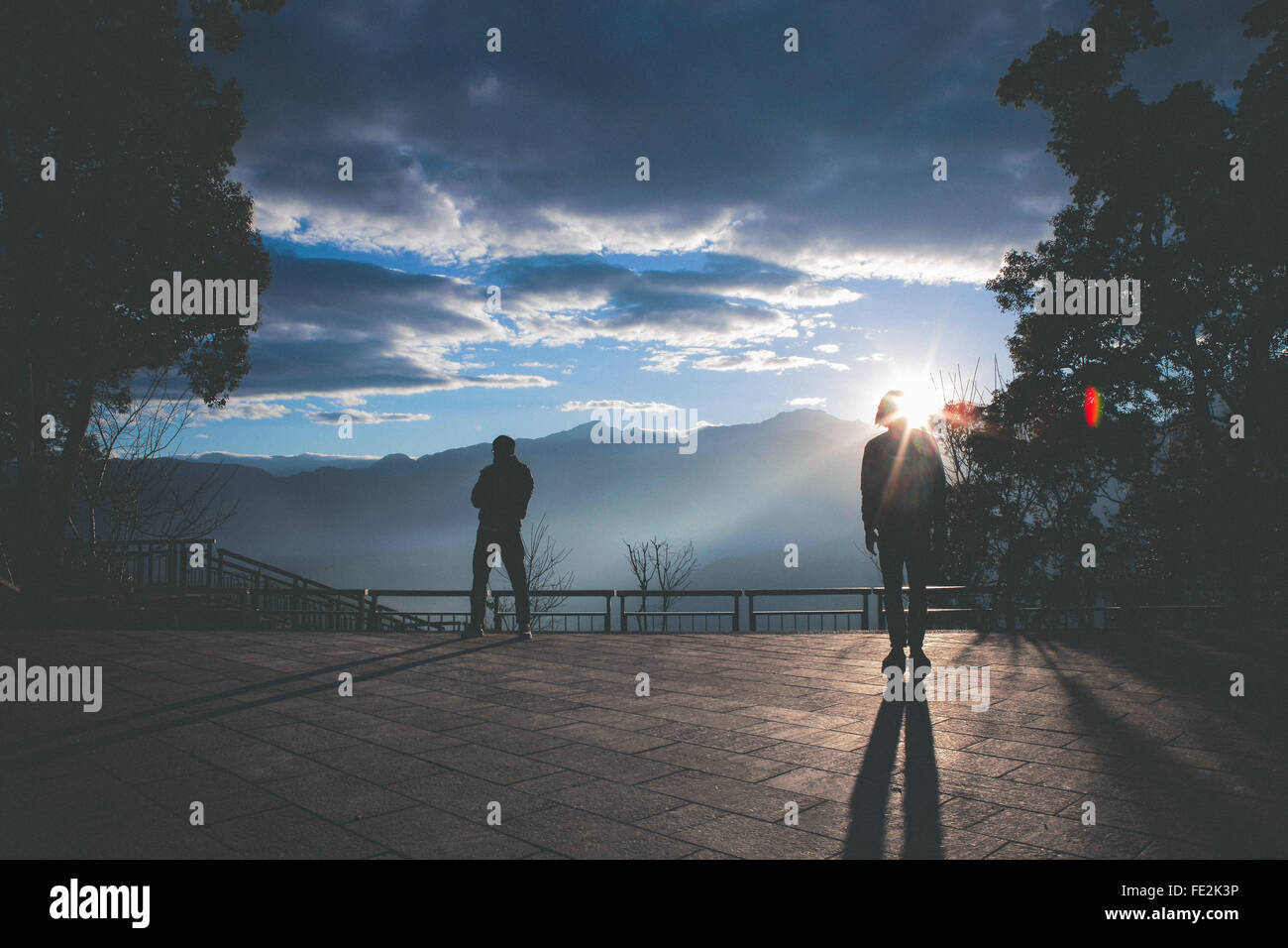 Men Standing At Observation Point By Silhouette Trees Stock Photo - Alamy