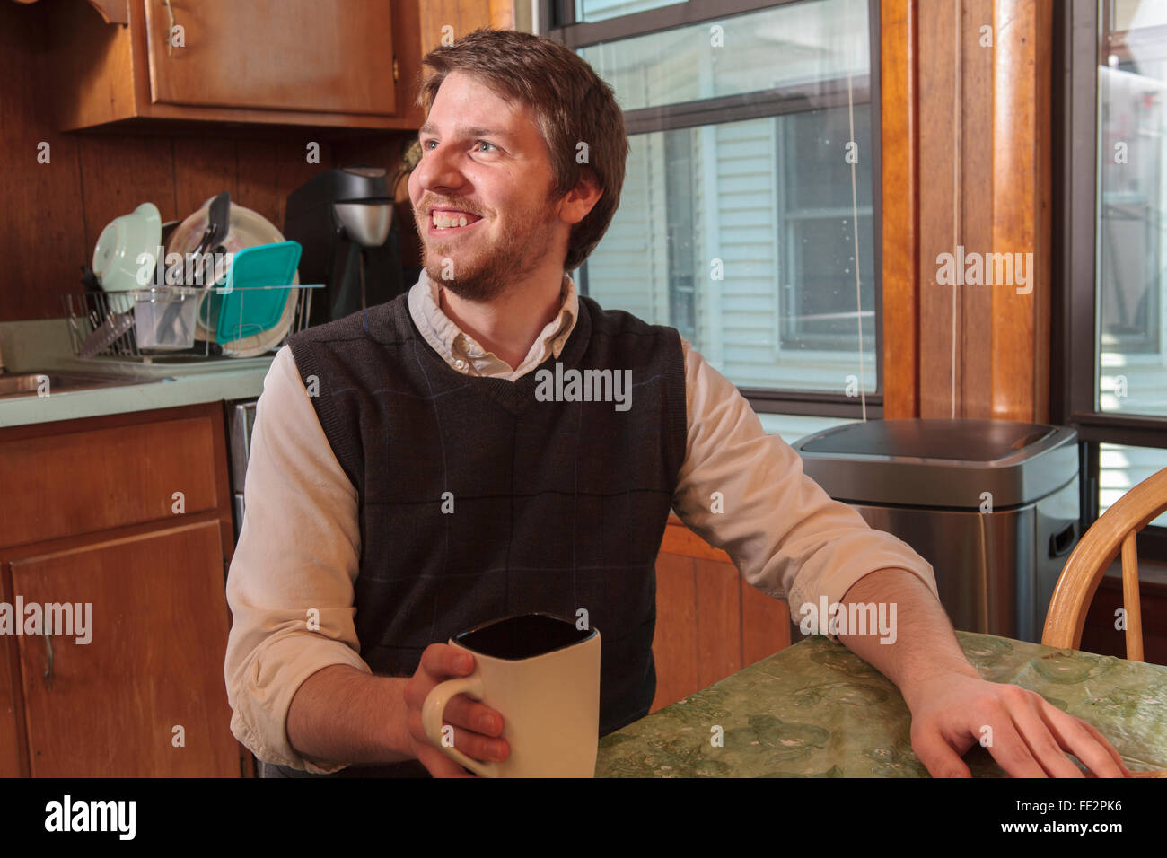 Young blind man sitting in his kitchen with a cup of coffee Stock Photo ...
