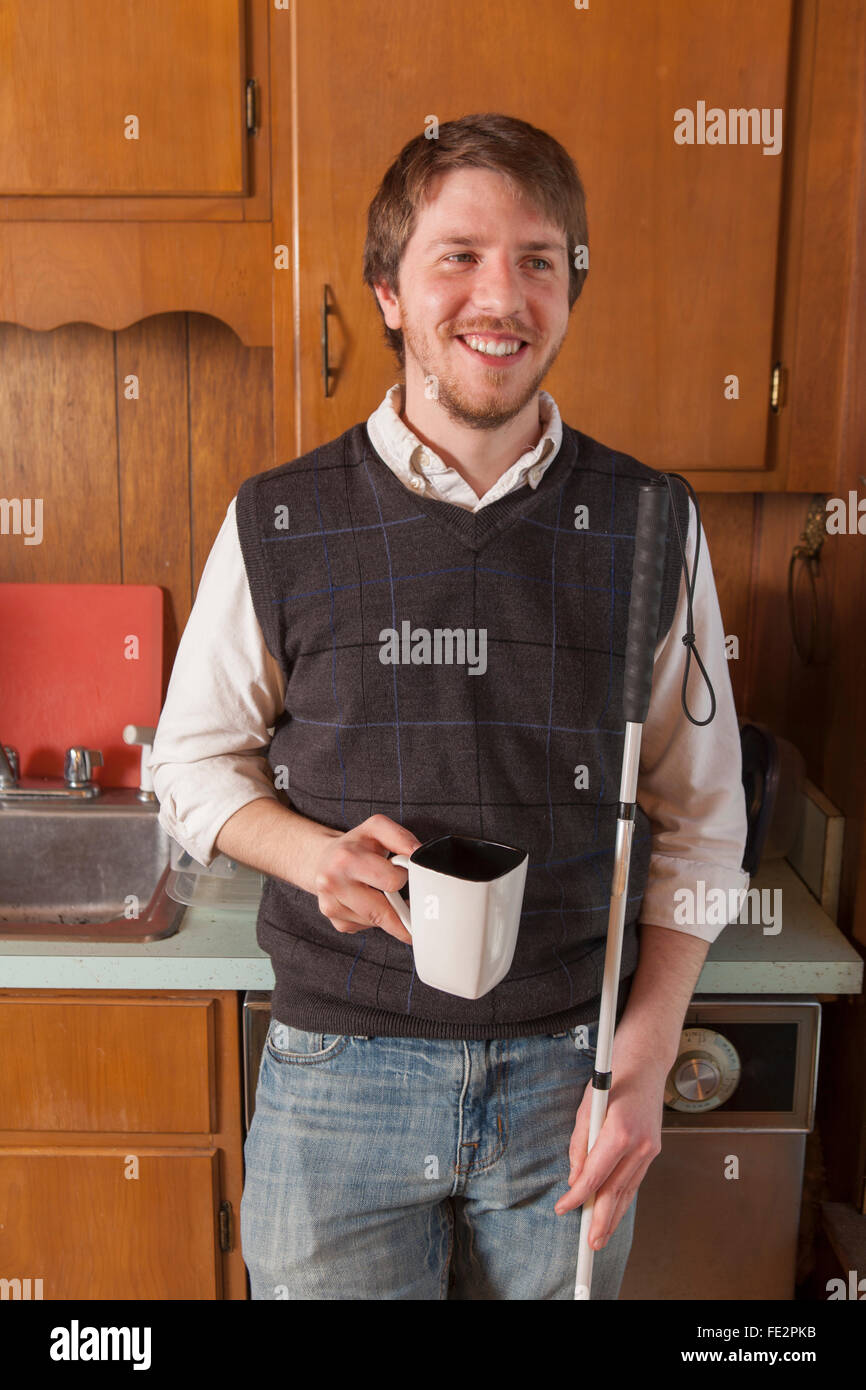 Young blind man standing in his kitchen with a cup of coffee Stock ...