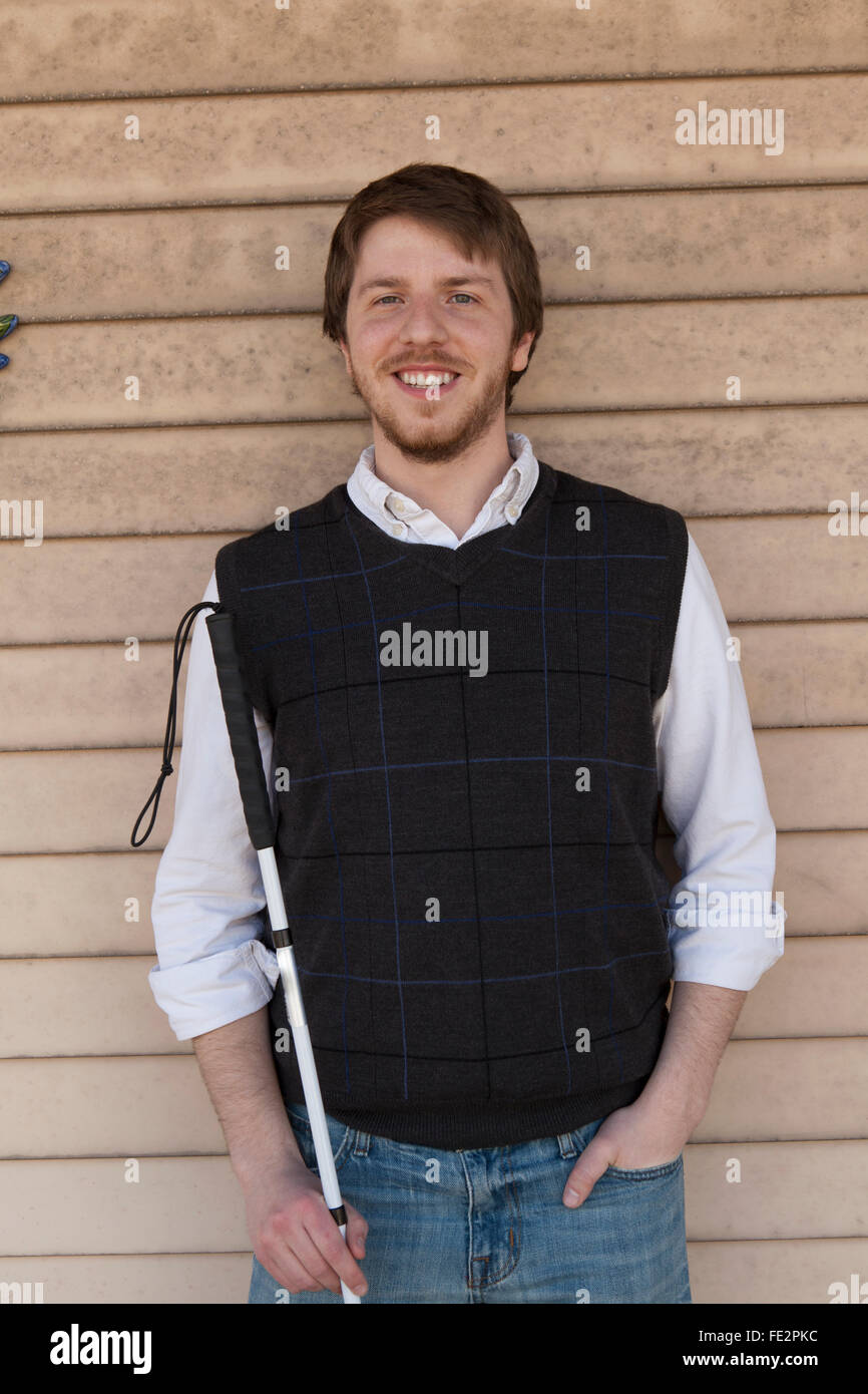 Young blind man outside his house smiling Stock Photo - Alamy